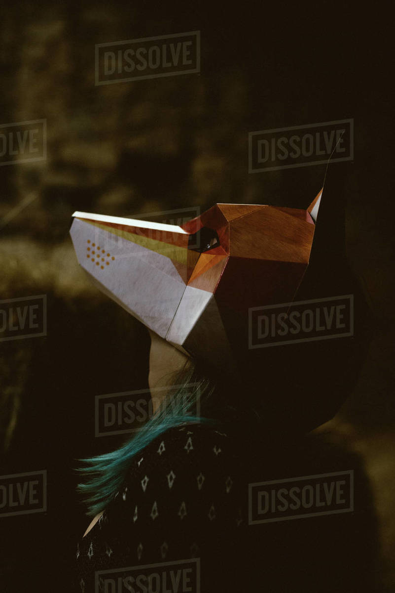 Anonymous female in paper fox mask walking in mysterious autumn forest ...