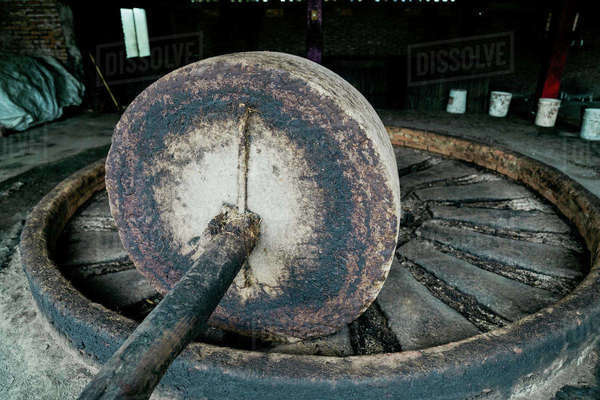 Empty grungy large mill press at traditional distillery in daylight ...