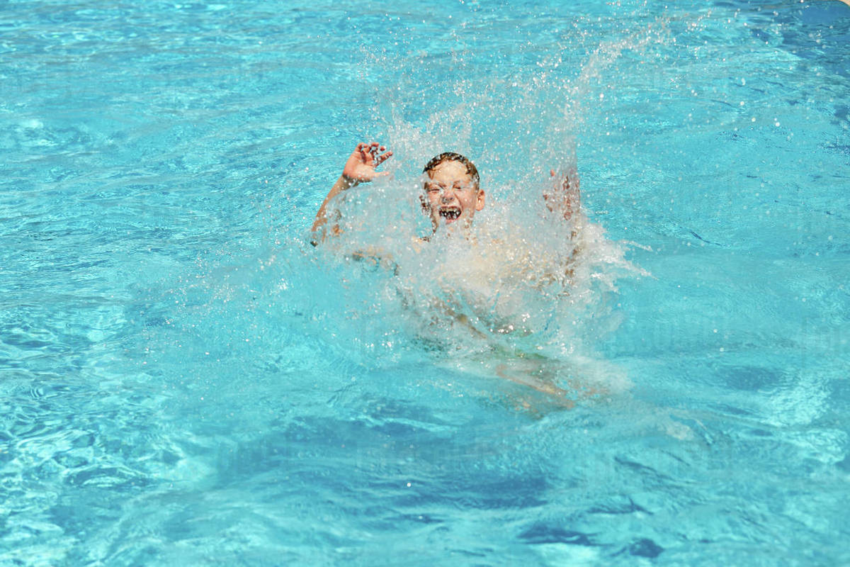 Kid jumping in swimming pool - Stock Photo - Dissolve