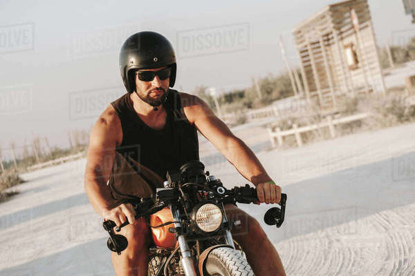 Strong man driving motorcycle - Royalty-free Stock Photo | Dissolve