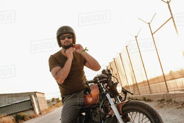 Strong man driving motorcycle - Royalty-free Stock Photo | Dissolve