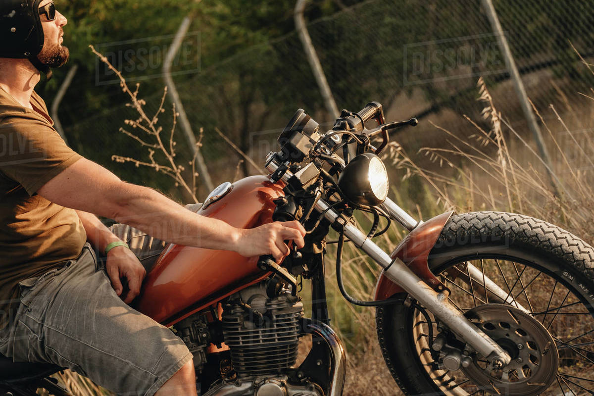 Strong man driving motorcycle - Stock Photo - Dissolve
