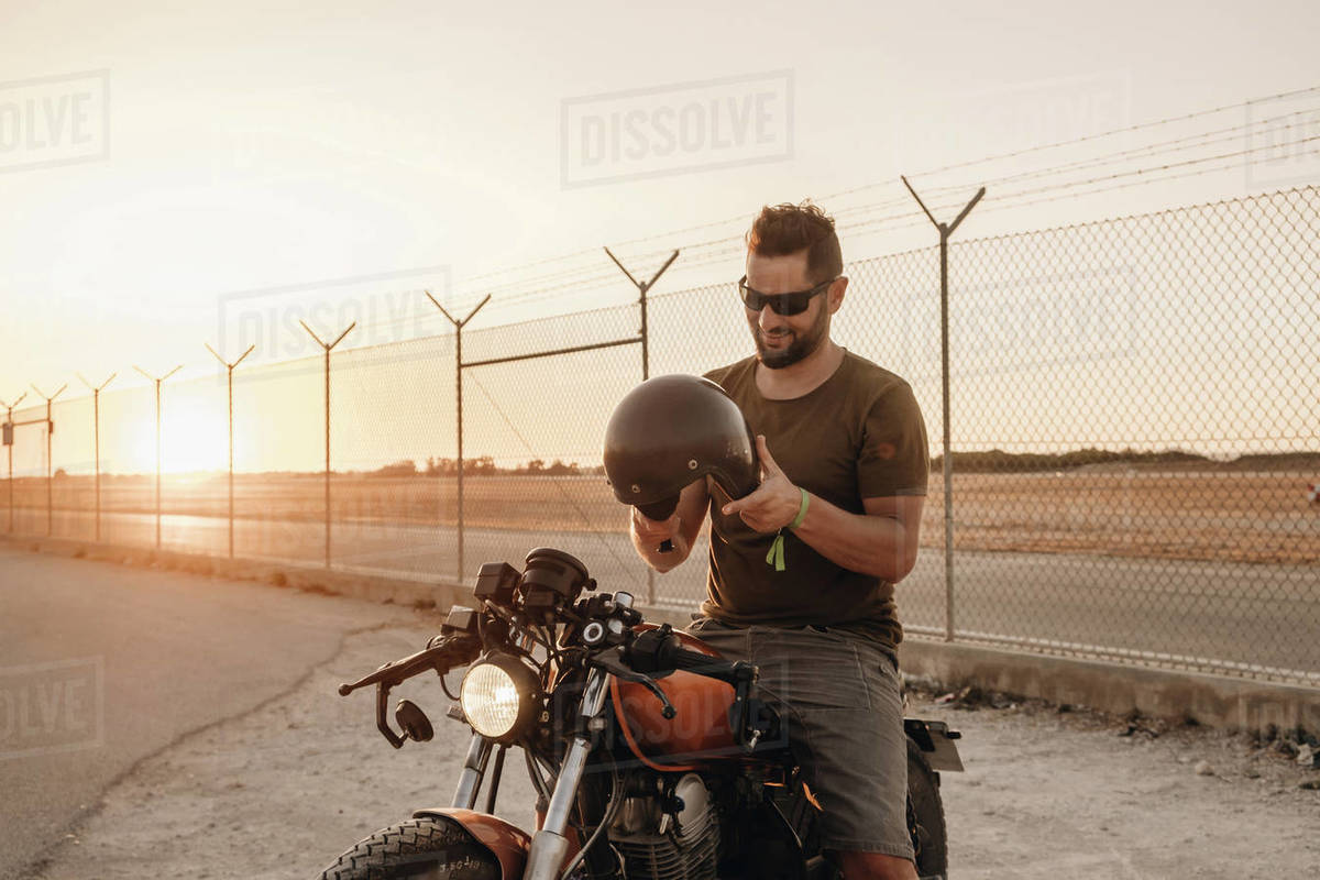 Strong man driving motorcycle - Royalty-free Stock Photo | Dissolve