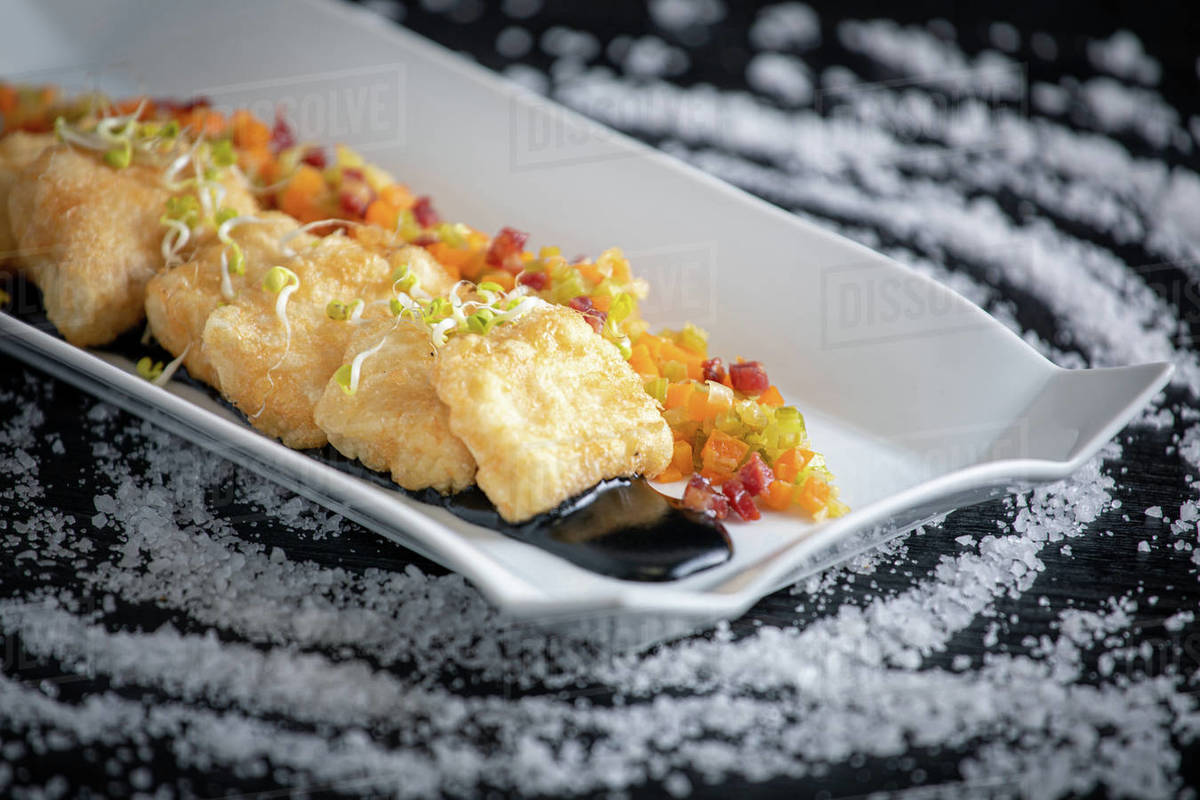Hake breaded with matignon in white rectangular plate - Royalty-free ...