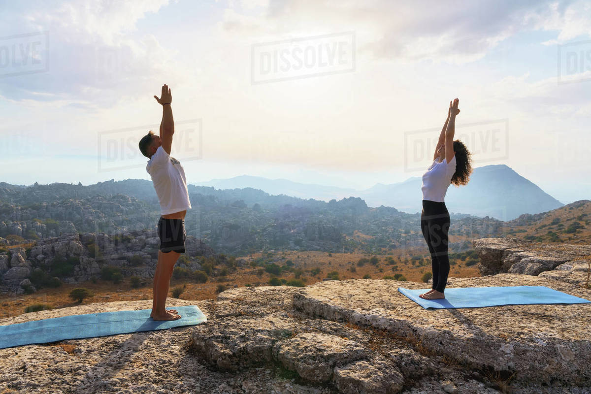 Full body side view of man and woman in activewear standing in Mountain ...