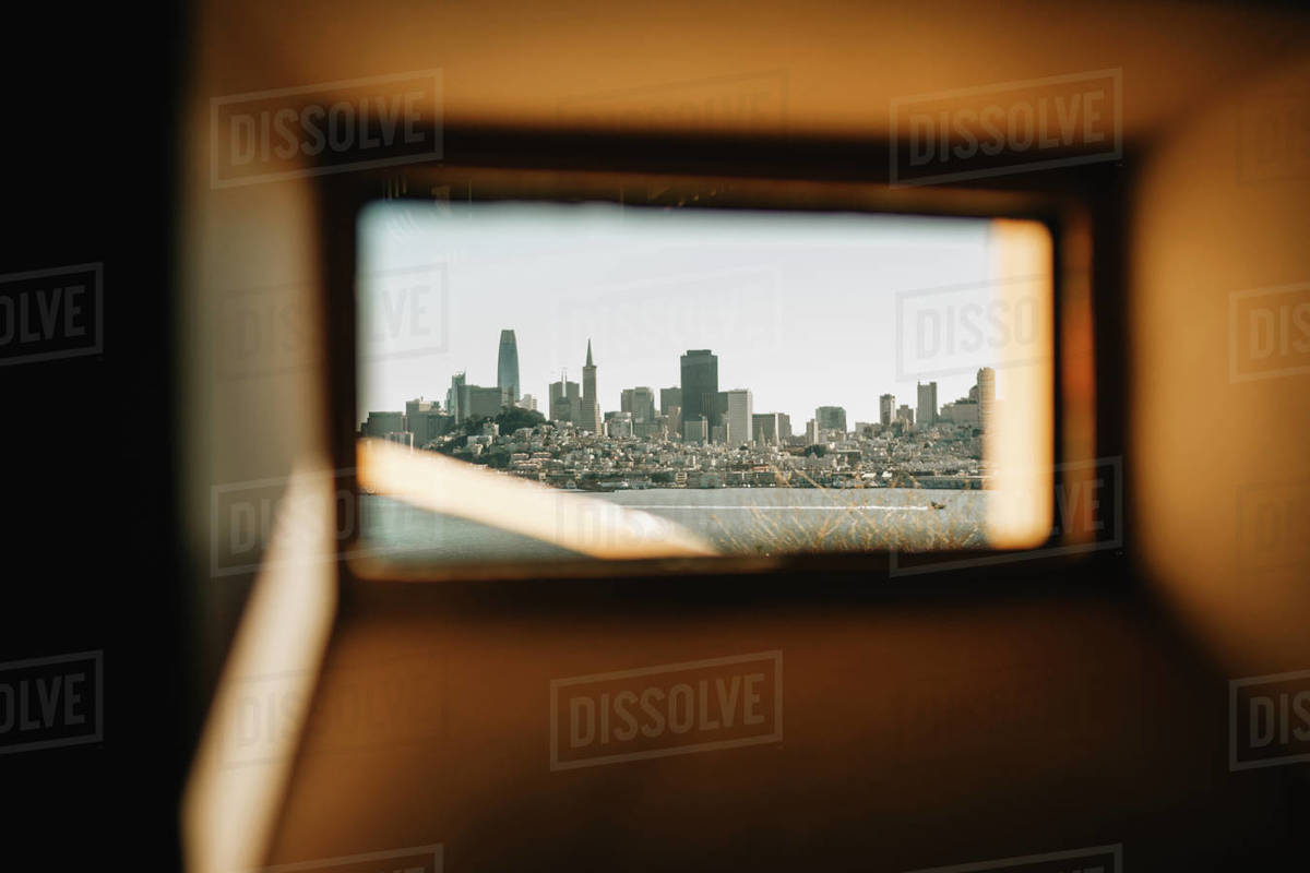 View of modern city through small window in Venice beach on sunny day ...