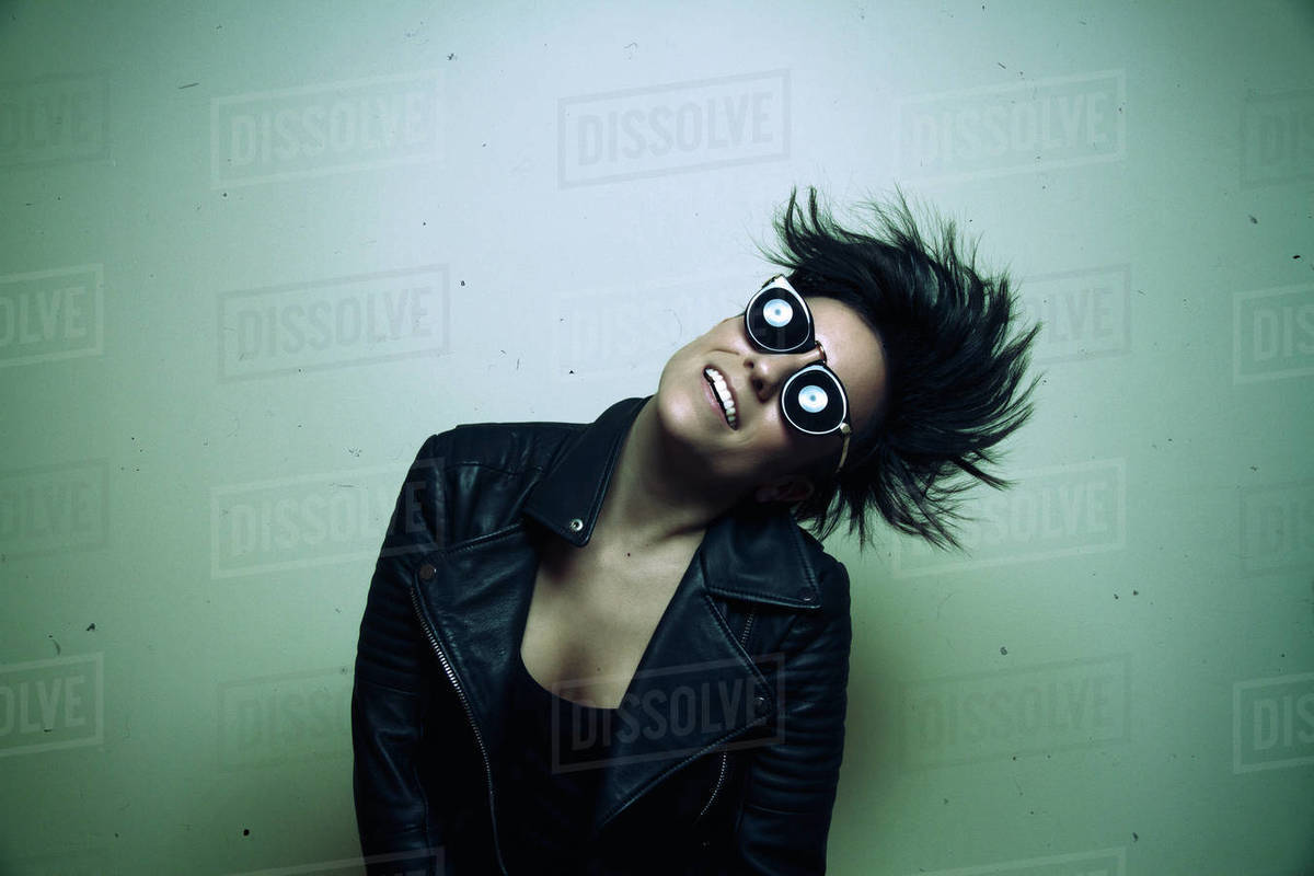 Strong young female rocker in leather jacket in studio - Royalty-free ...