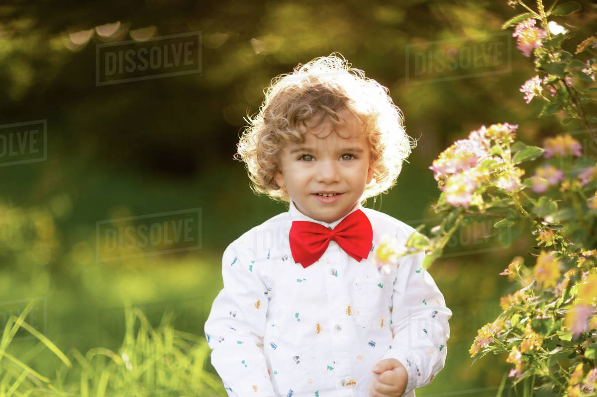 Overjoyed male child having fun in green park - Stock Photo - Dissolve