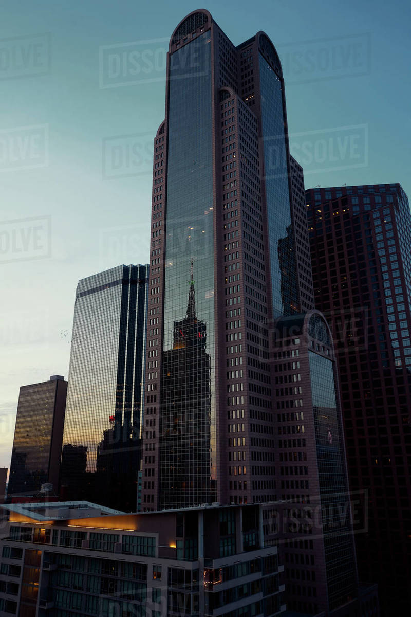From below modern skyscrapers with blue sky on background at dusk in ...