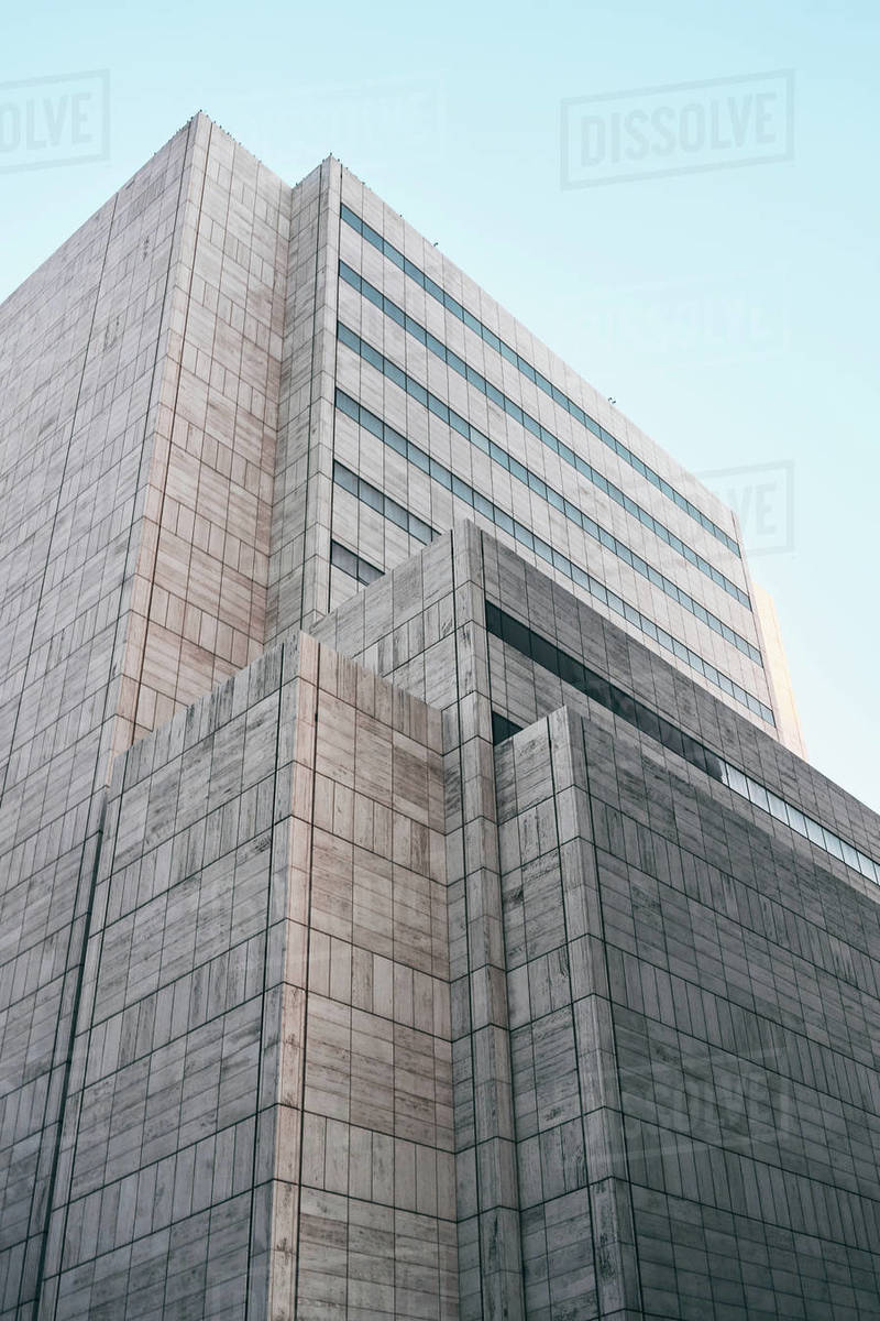 From below modern building with creative architecture under blue sky on ...