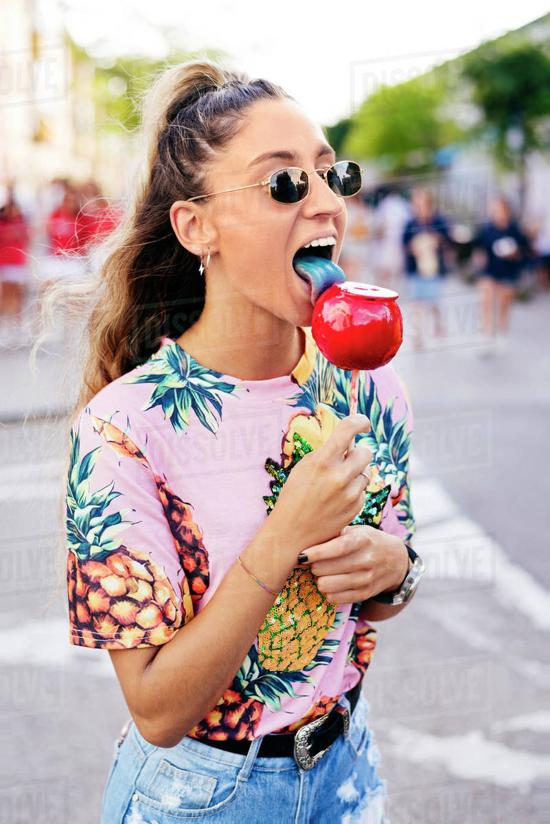 Cheerful lady having fun enjoying sweet candy apple - Royalty-free ...