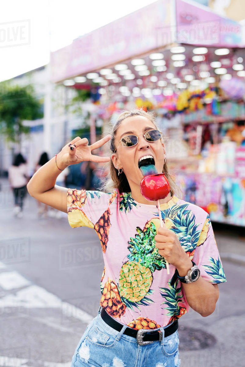 Cheerful lady having fun enjoying sweet candy apple - Royalty-free ...