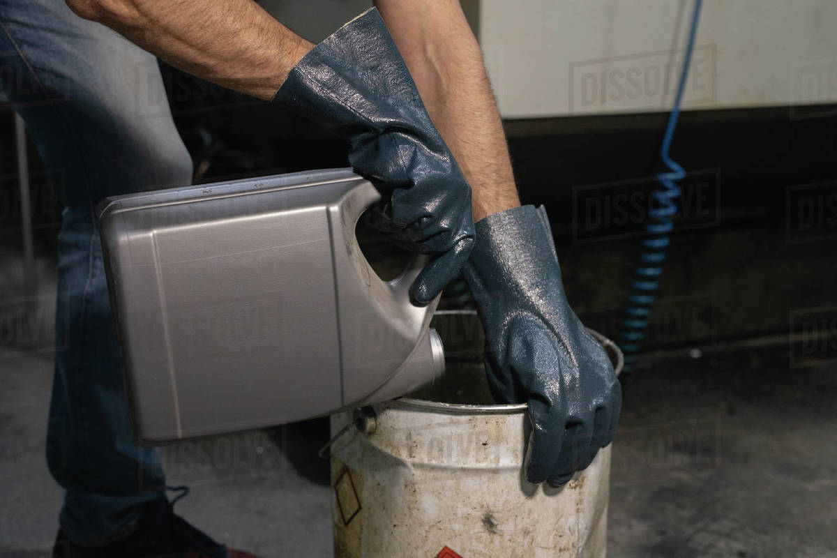 Faceless male employee working at workshop - Stock Photo - Dissolve