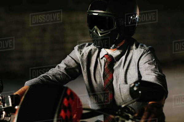 Elegant man sitting on his pretty motorcycle inside a garage - Stock ...