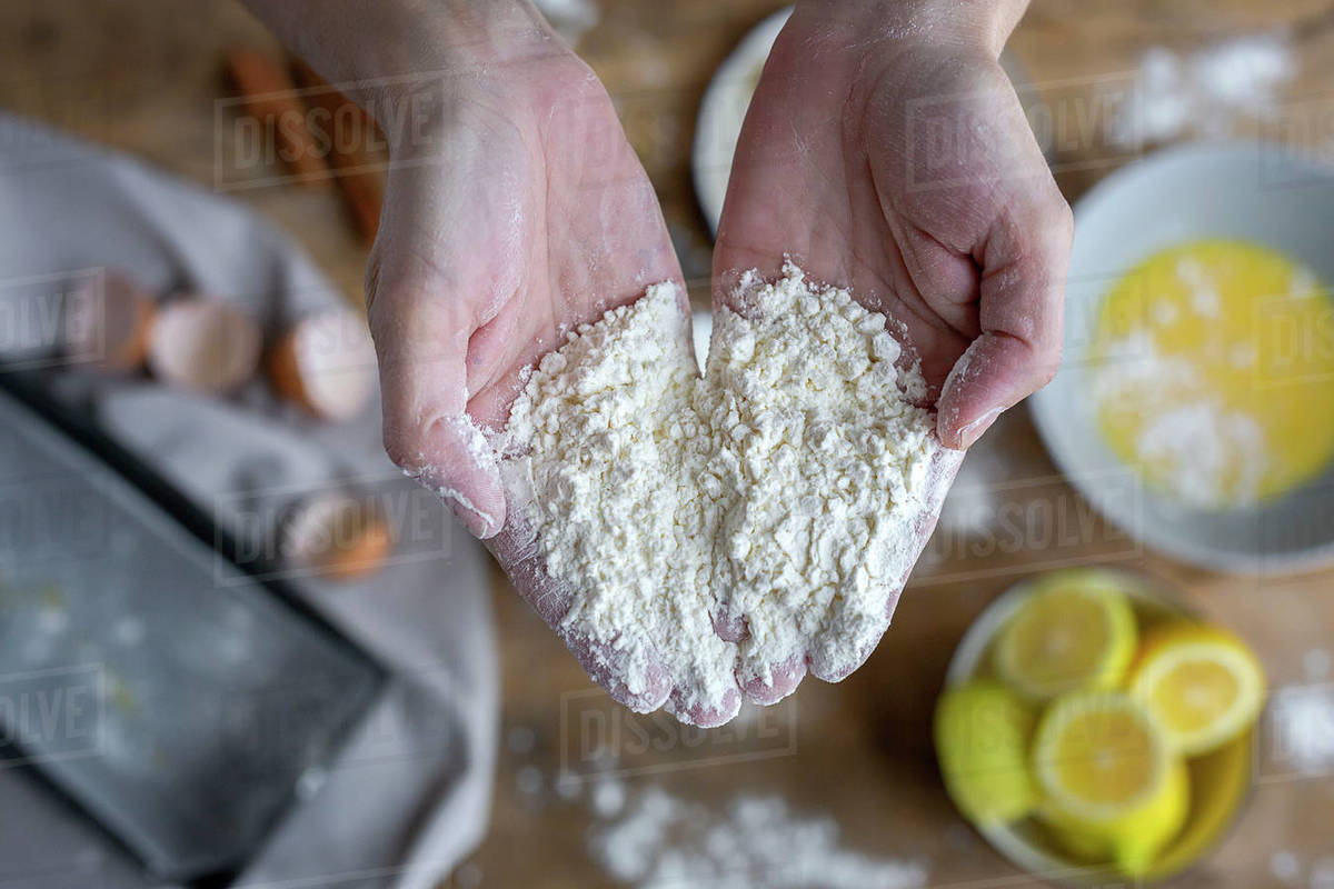Top view of cropped unrecognizable woman showing hands full of flour ...
