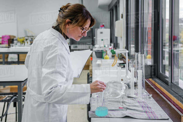 Adult woman working in chemistry lab - Royalty-free Stock Photo | Dissolve