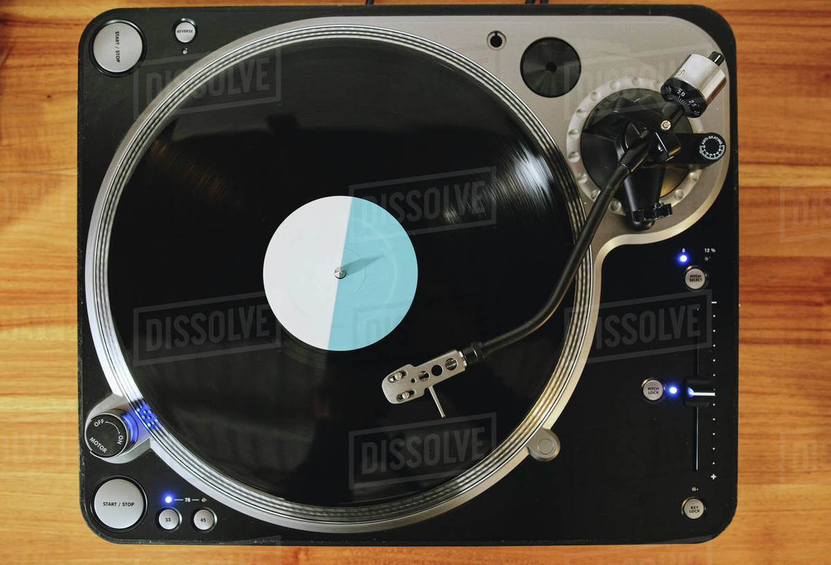 Top view of contemporary vinyl record player with retro disc placed on ...