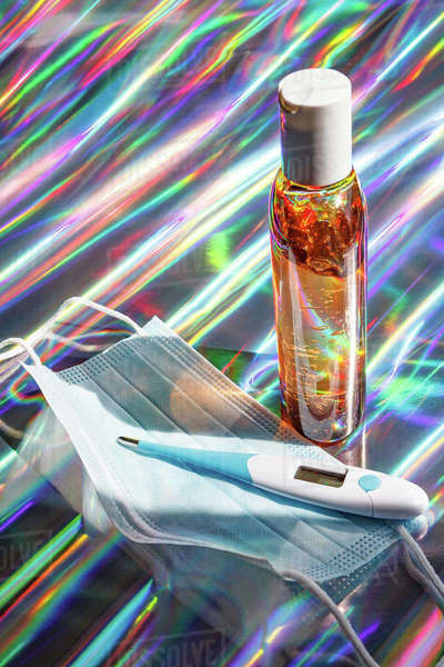 Glass of antiseptic liquid and forensic face respirator mask placed ...