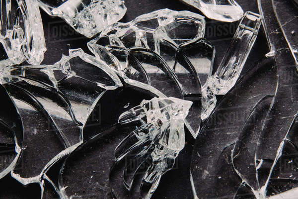 Abstract background with shiny pieces of broken transparent glass on ...