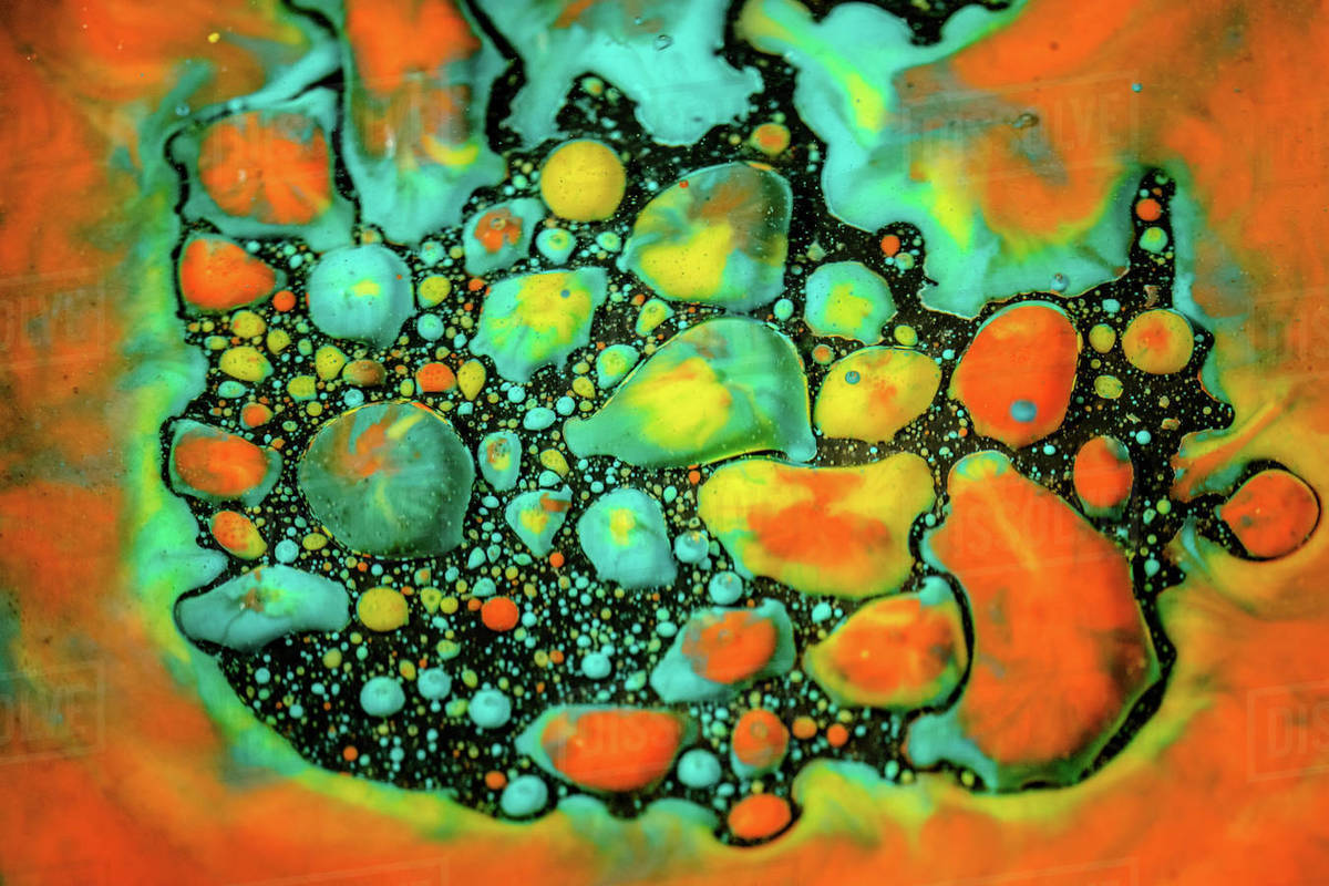 Backdrop with top view of abstract vivid blue and orange inky circles ...