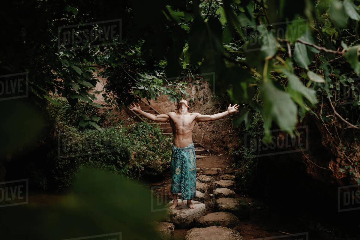 Full body unrecognizable muscular shirtless male in traditional ...