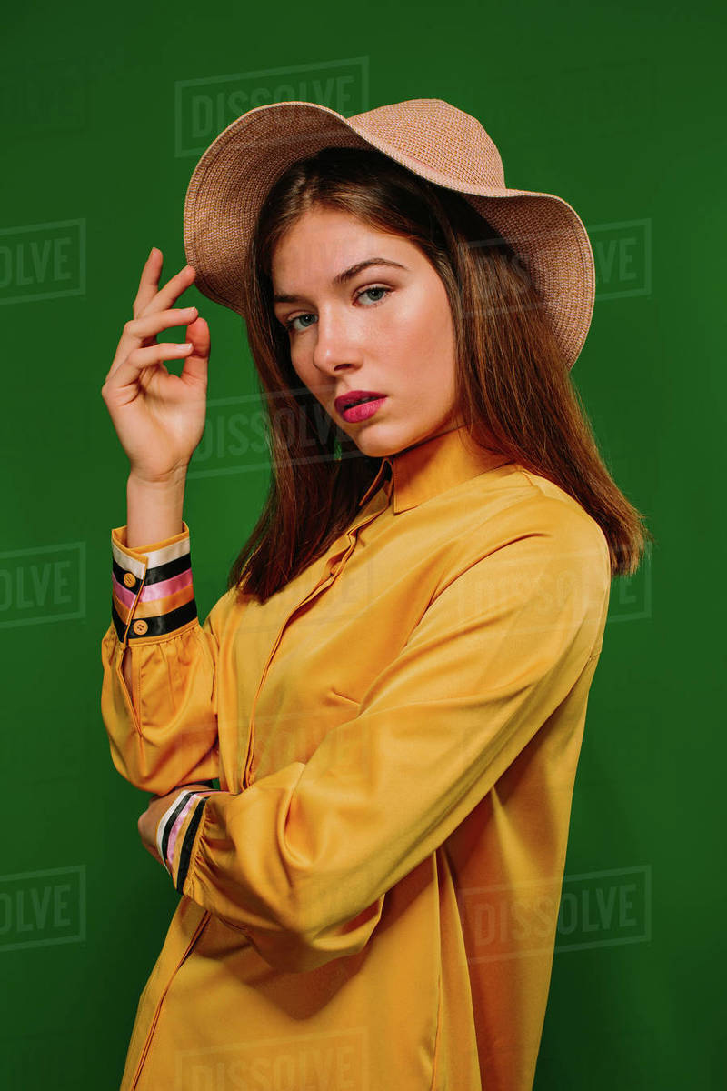 Side view of trendy confident millennial female in colorful clothes and ...