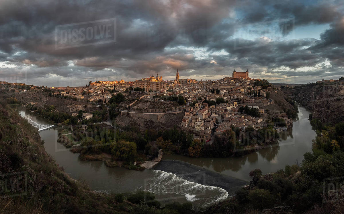 Aerial view of aged town with medieval houses located on shore of river ...