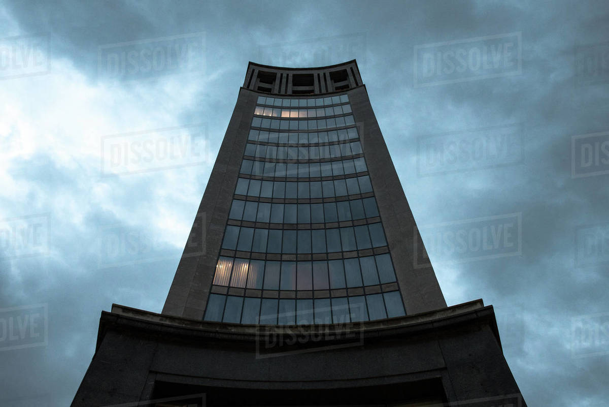 Perspective view from below of tall tower building with stone facade ...