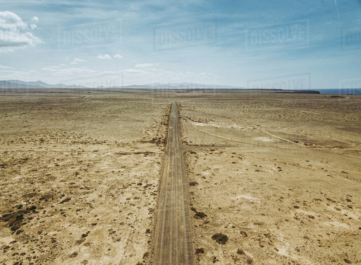 Car driving on road in picturesque desert - Stock Photo - Dissolve