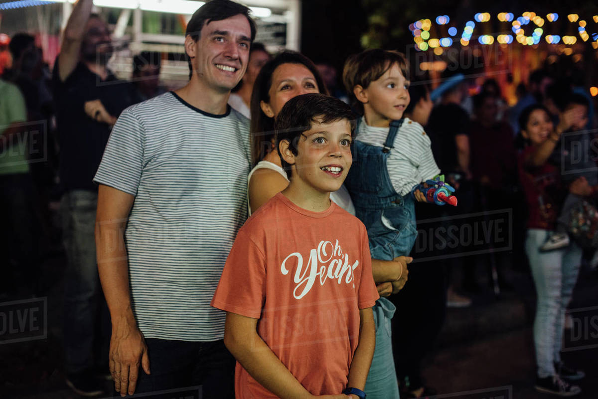 Cheerful family on fairground in city - Royalty-free Stock Photo | Dissolve