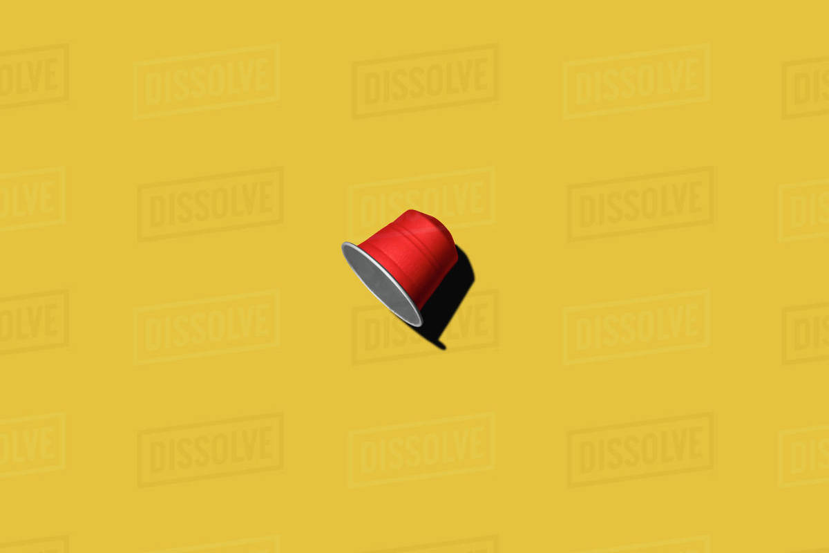 Top view of red coffee pod placed on yellow background - Stock Photo ...