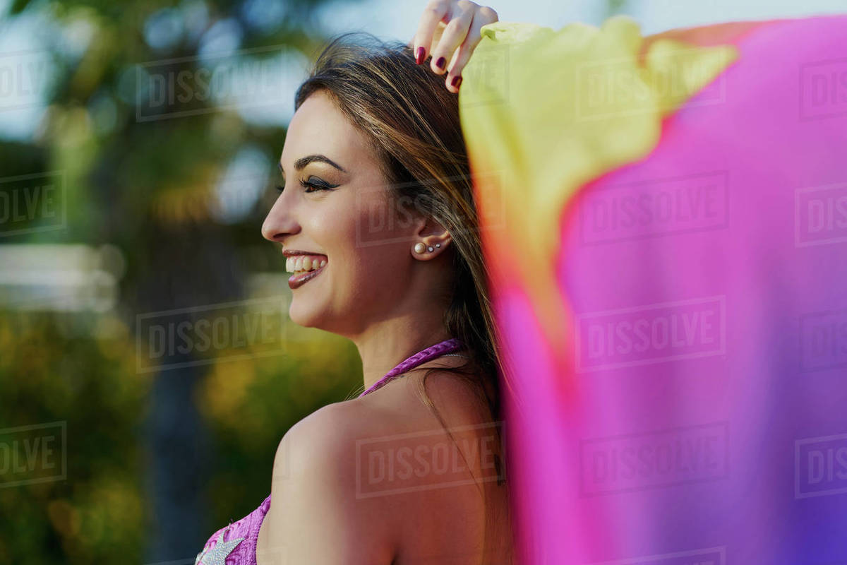 Graceful female belly dancer in colorful costume dancing with shawl in ...