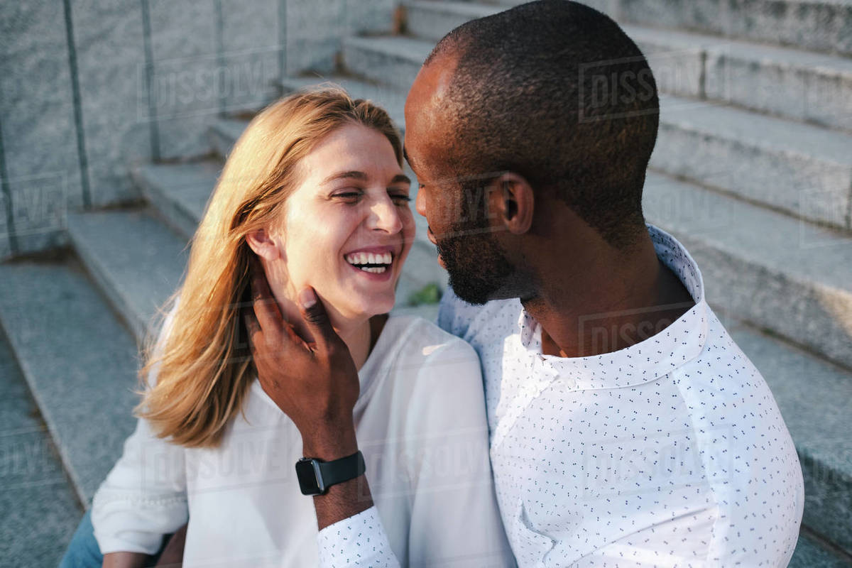 Content black boyfriend and smiling girlfriend while bonding sensually ...