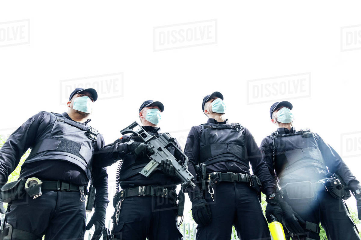 Full body squad of Spanish police officers in protective gears with ...