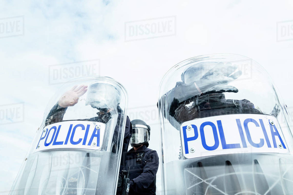 Low angle of anonymous police soldiers in protective uniforms and ...