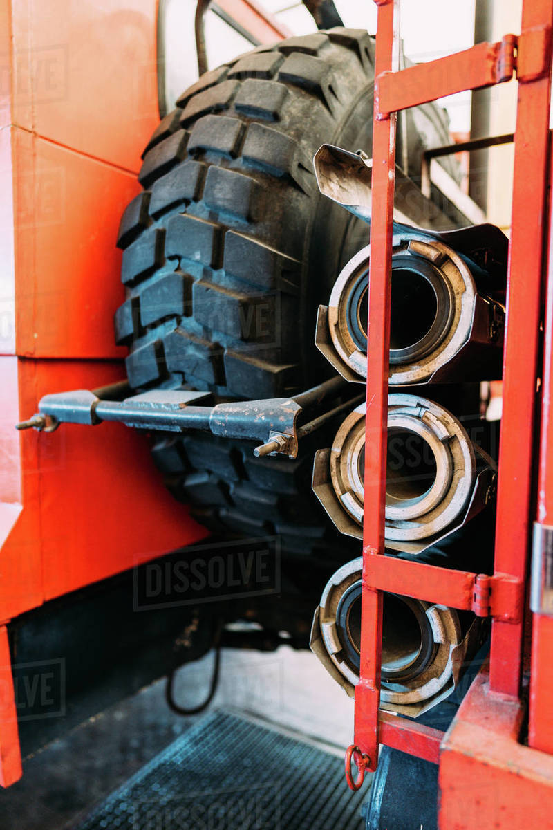 Spare wheel with rubber tire and uneven surface near similar rolls made ...