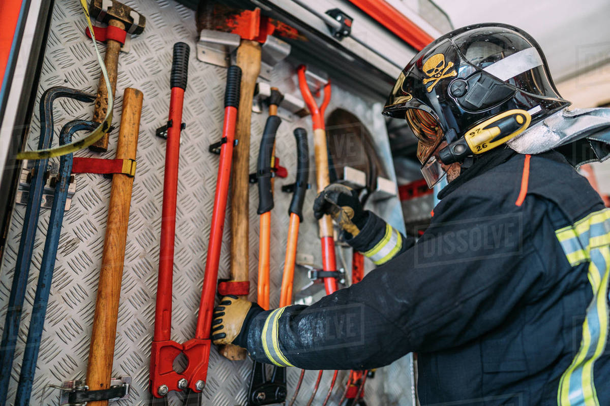 From below side view of anonymous fireman in uniform and protective ...