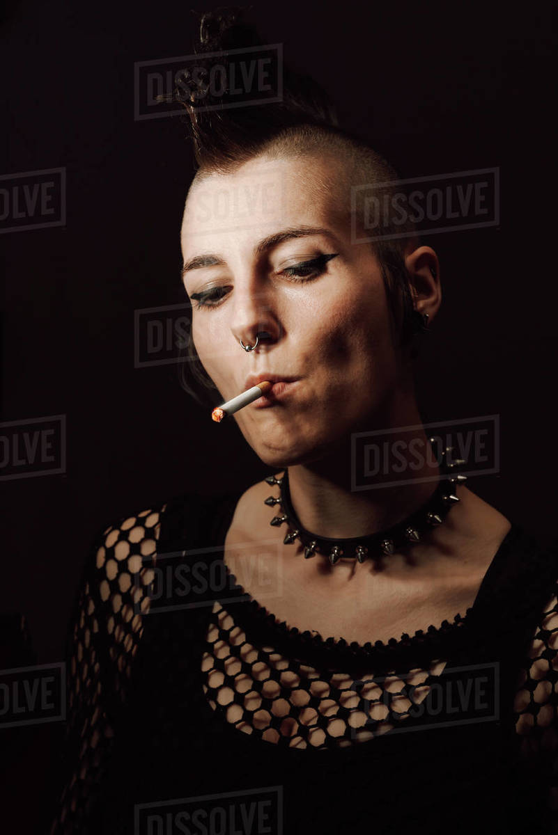 Adult female with mohawk and piercing smoking cigarette - Stock Photo ...
