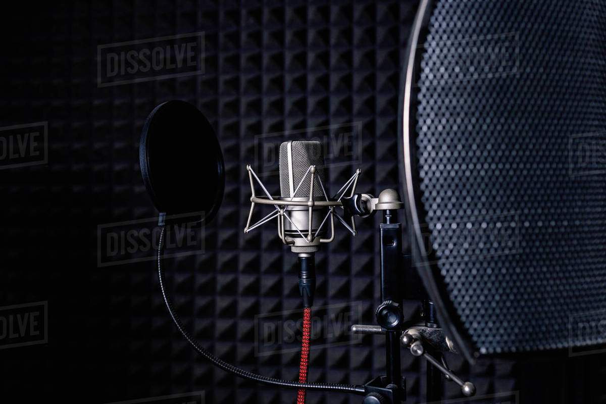 Contemporary metal microphone with wire placed on background of ...