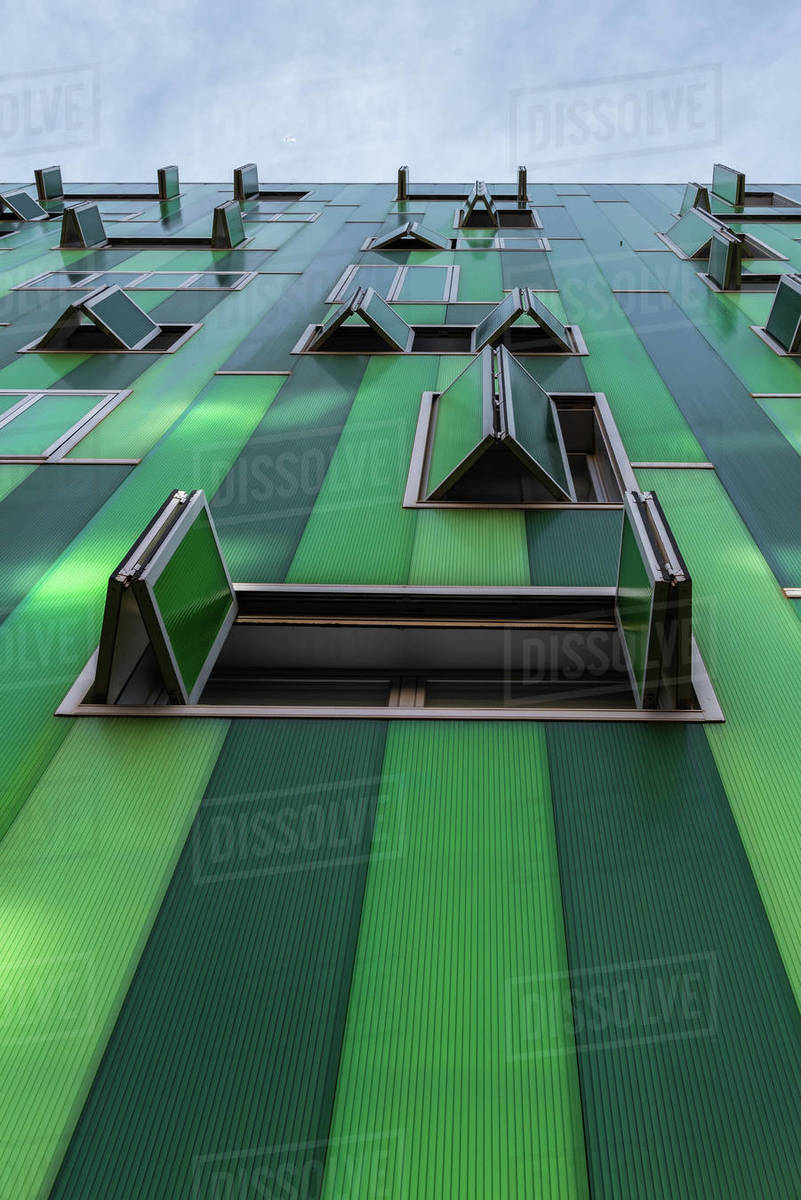 From below contemporary building with vivid green facade and opened ...