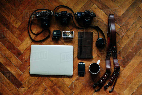 Flat lay of assorted photography devices and gear placed on shabby ...