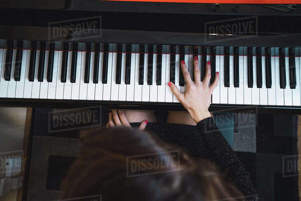 Overhead view of pianist playing piano at home - Stock Photo - Dissolve