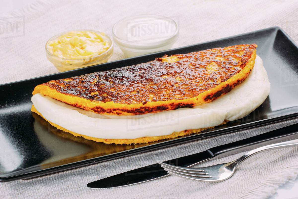 Cachapa, typical Venezuelan dish made with corn and stuffed with white ...