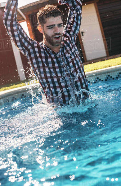 Dressed man in swimming pool - Royalty-free Stock Photo | Dissolve
