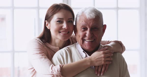 Happy grown granddaughter hug senior grandad cuddle look at camera - 4K ...