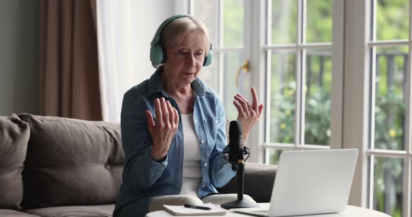 Older woman talks into microphone, record educational professional ...