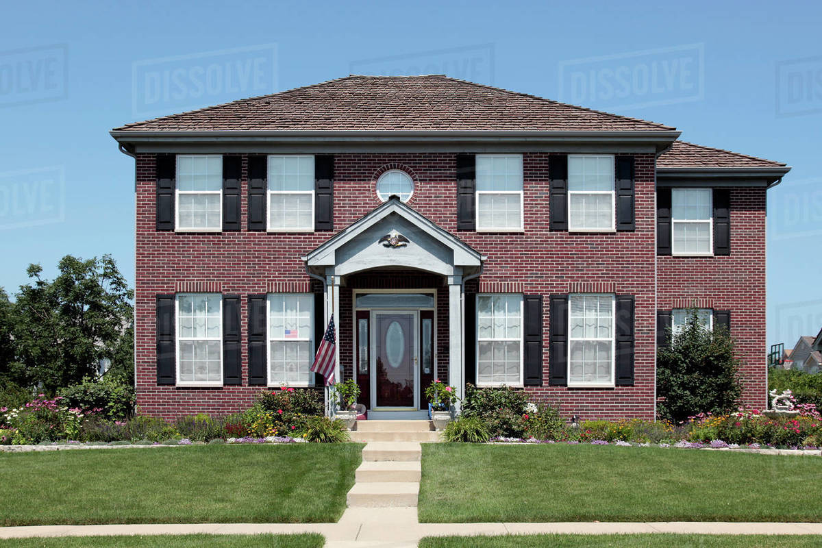 Brick home with arched entry and American flag - Royalty-free Stock ...