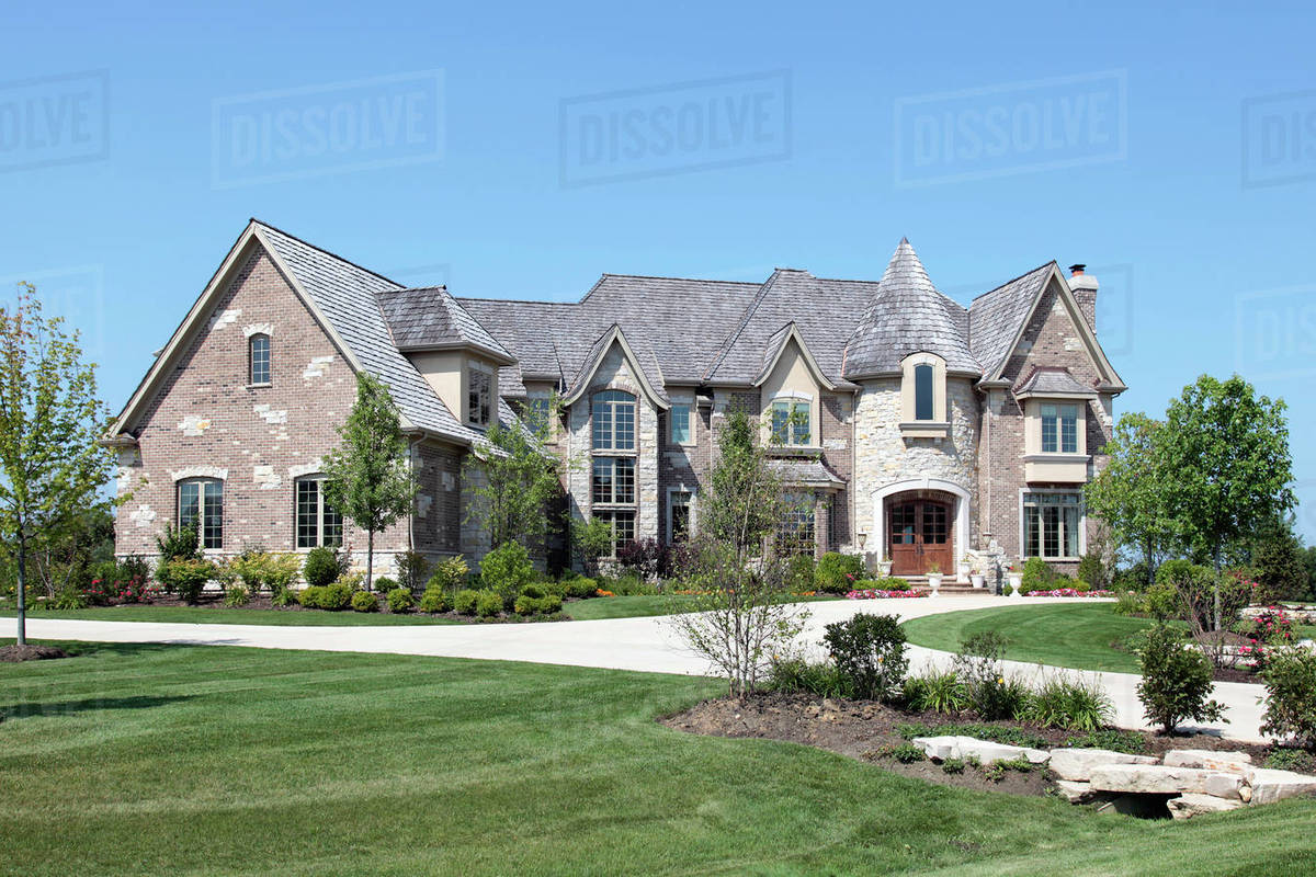 Large luxury brick home with stone turret - Royalty-free Stock Photo ...