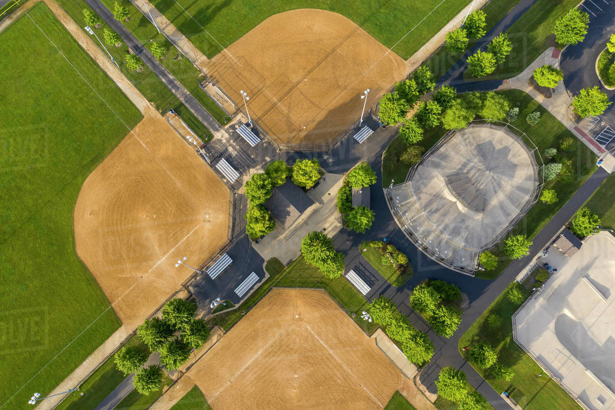 Aerial view of a suburban baseball/softball sports complex with batting ...
