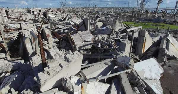 Drone scene of a city destroyed by natural disaster. Camera flying low ...